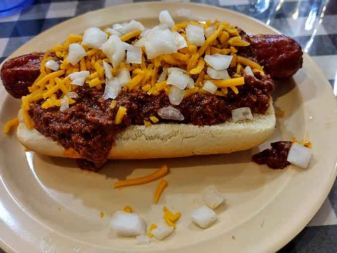 A classic chili dog topped with cheese and onions delivers nostalgic flavor in every delicious bite.