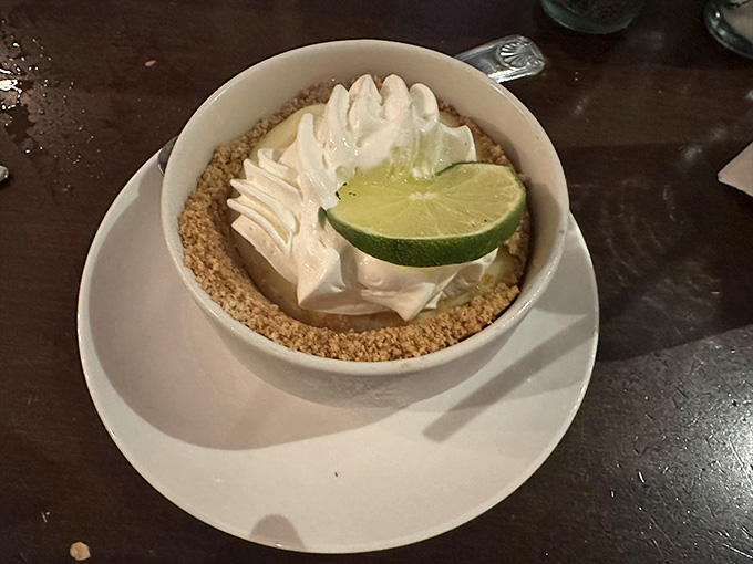 Key lime pie topped with whipped cream and a lime slice, the dessert equivalent of a Florida vacation.