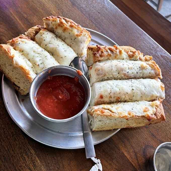 Cheese bread that's basically garlic-kissed happiness served with marinara for dunking and pure joy.