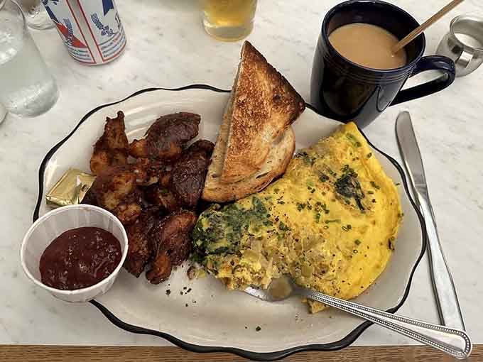 Fluffy omelet, crispy bacon, and buttered toast compose a breakfast symphony that would make Sinatra weep with joy.