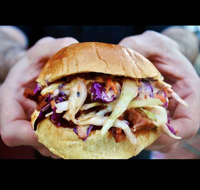 Pulled pork on a bun with slaw, proving that simple comfort food never goes out of style.