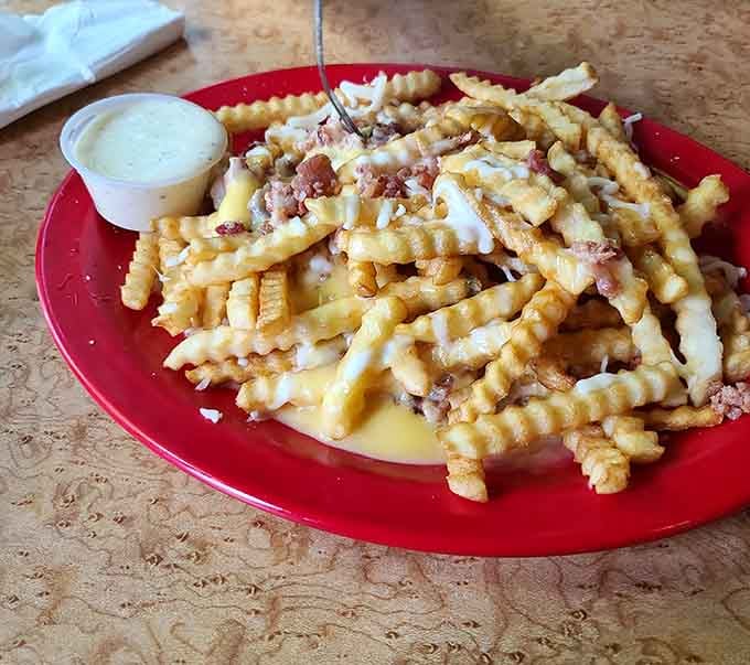 Waffle fries buried under bacon and cheese; this is what happens when restraint takes a well-deserved vacation.