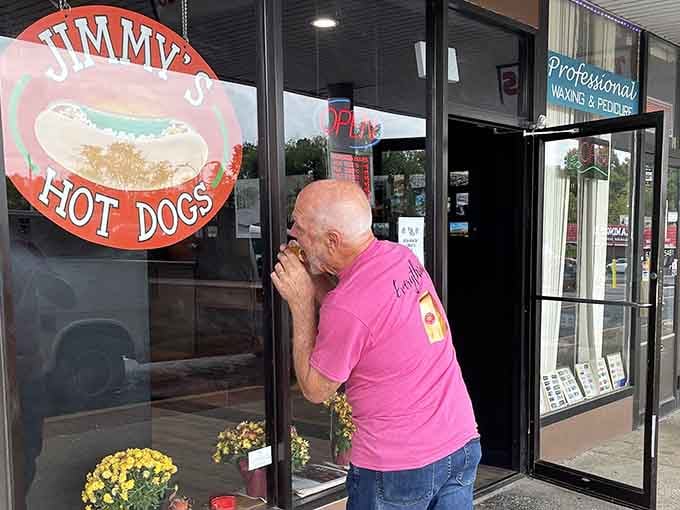 A man peers longingly through the window at Jimmy's Hot Dogs, where Chicago-style dreams are made.