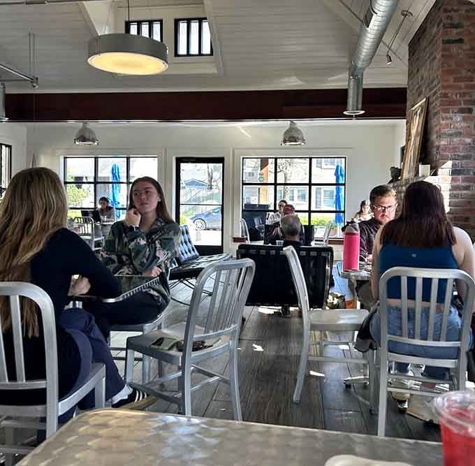 Mismatched chairs and exposed brick create the kind of lived-in comfort that makes strangers feel like neighborhood regulars instantly.