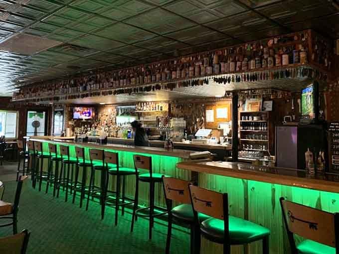 That green glow says the bar is open, and the beer stein collection says they take their beverages seriously.