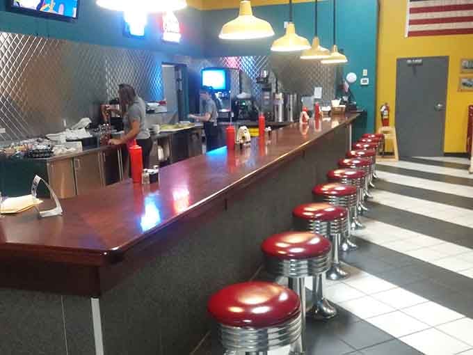 Classic diner counter seating with chrome stools invites solo diners to enjoy breakfast while watching the kitchen magic happen.