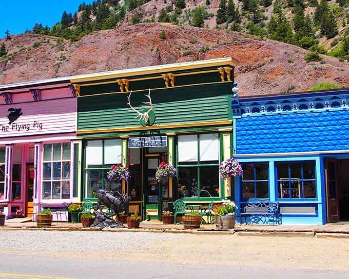 That green building with its ornate trim stands proud like it's been waiting since the 1800s to have its photo taken.
