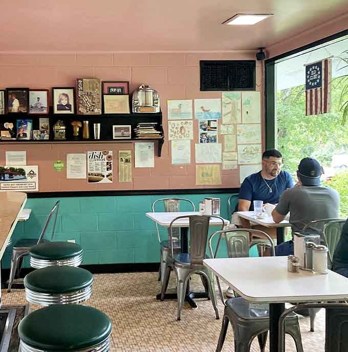 Pink walls, green booths, and hanging plants create that authentic diner vibe you just can't fake or replicate anywhere else.