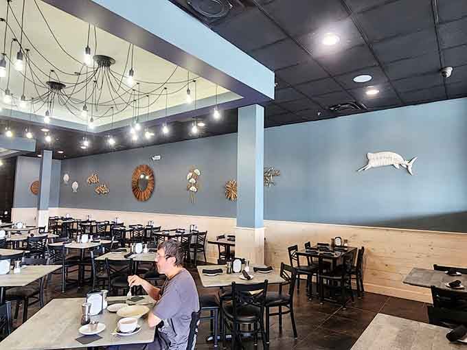 Spacious dining room with ocean-themed art offers plenty of elbow room for serious seafood enthusiasts to enjoy their feast.