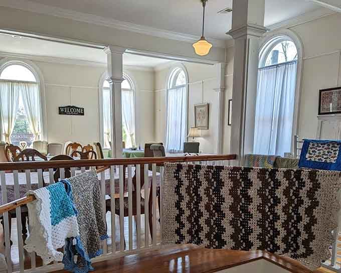 The upstairs dining area with its white columns and hardwood floors feels like stepping into a Southern novel.