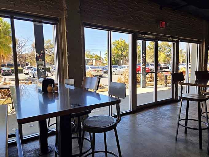 Floor-to-ceiling windows flood the space with natural light, perfect for Instagram photos of your pizza conquest.