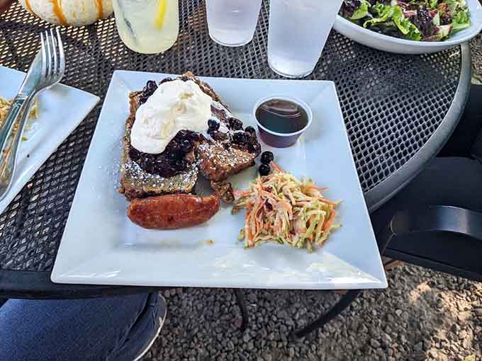 French toast that's been elevated to gourmet status, complete with sausage links and fresh fruit for good measure.
