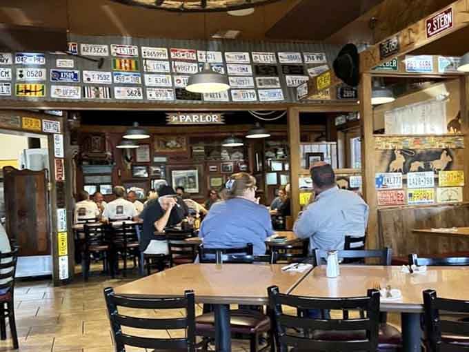 License plates covering the walls tell stories of travelers who found this gem and never forgot it.