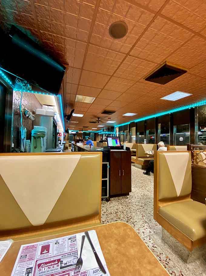 Classic diner booths stretching into the distance like a delicious hallway of endless breakfast possibilities ahead.