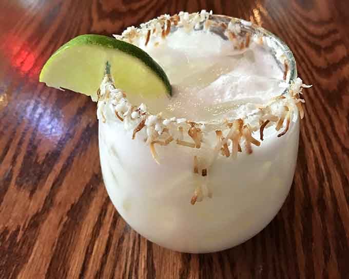 A coconut-rimmed margarita that tastes like vacation in a glass, even if you're just escaping Tuesday afternoon.