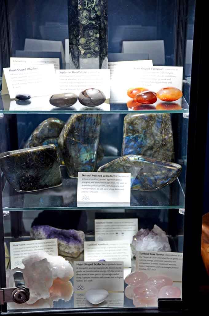Polished labradorite and heart-shaped stones displayed with descriptions, perfect for crystal enthusiasts and curious newcomers alike.