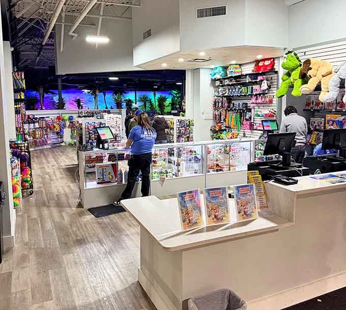 The redemption counter where tickets transform into treasures and adults pretend they're shopping for kids.