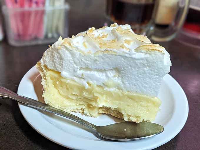 Lemon meringue pie with peaks so tall they could have their own weather system up there.