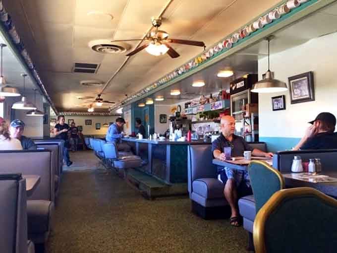 Real people enjoying real food in real booths, the trifecta of authentic diner culture alive.