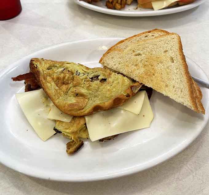 An omelet so generously stuffed with bacon it forgot what moderation means, and we're completely fine with that.