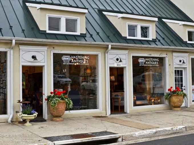 Hastening Antiques welcomes browsers with flower boxes and wide windows, because even furniture shopping deserves a side of curb appeal.