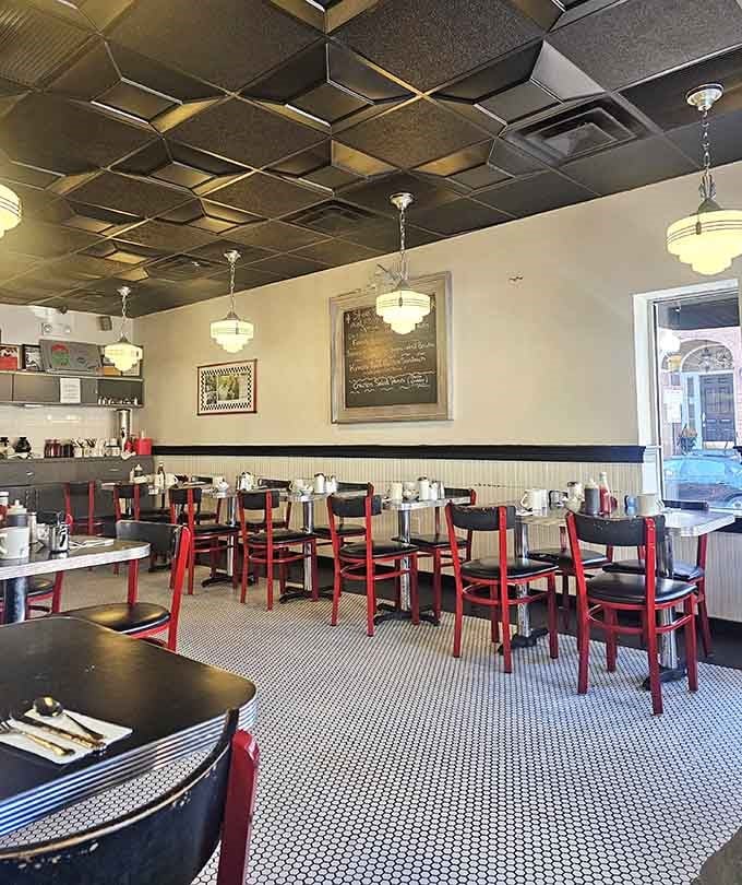 Classic diner seating with black tables and red chairs invites you to settle in and stay awhile.