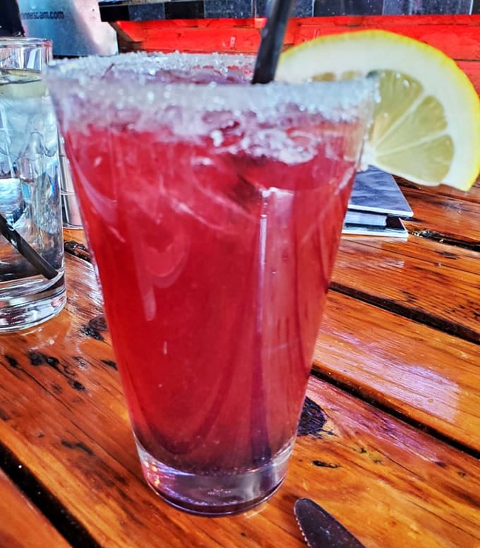 A refreshing blackberry lemonade with a salted rim offers the perfect balance of sweet, tart, and salty.