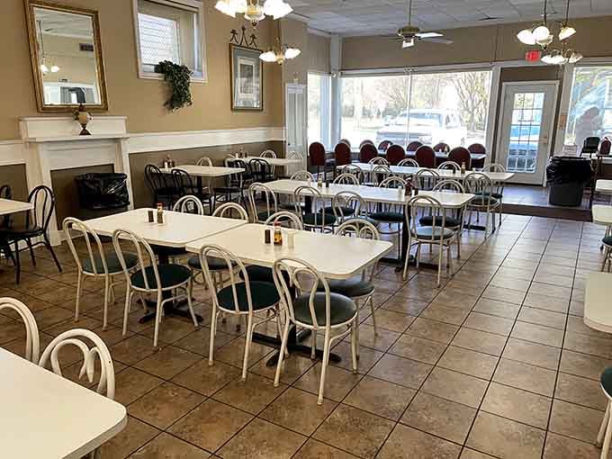 Clean, welcoming dining room where the decorative fireplace adds charm without trying too hard to impress anyone passing through.