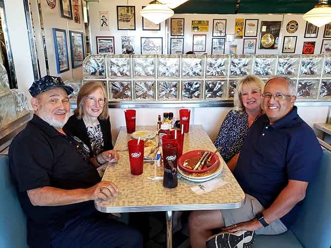 Happy diners in a vintage booth with Dr Pepper &ndash; this could be a Norman Rockwell painting, but tastier.