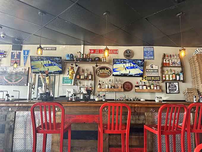Bar seating with Michigan memorabilia overhead, where sports fans and pizza lovers unite in delicious harmony.