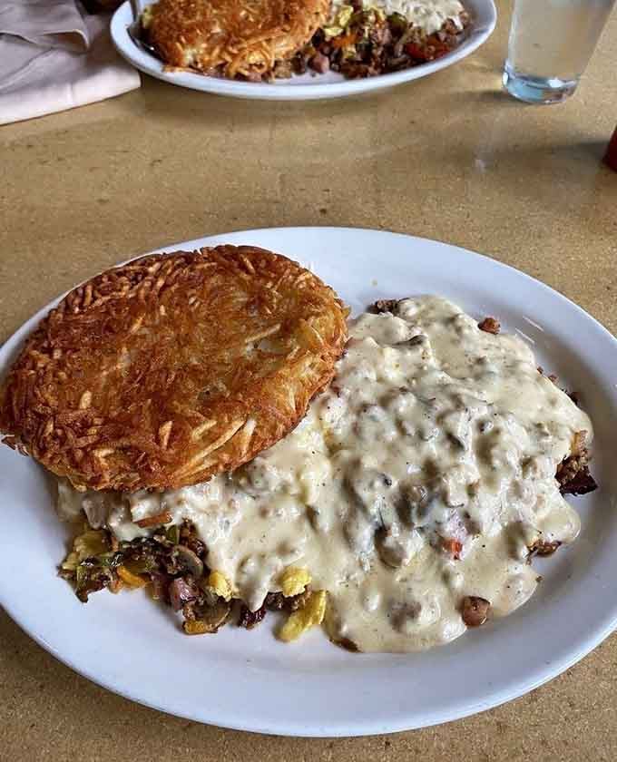 That massive hash brown scramble loaded with meat and veggies proves breakfast can be both hearty and beautiful.