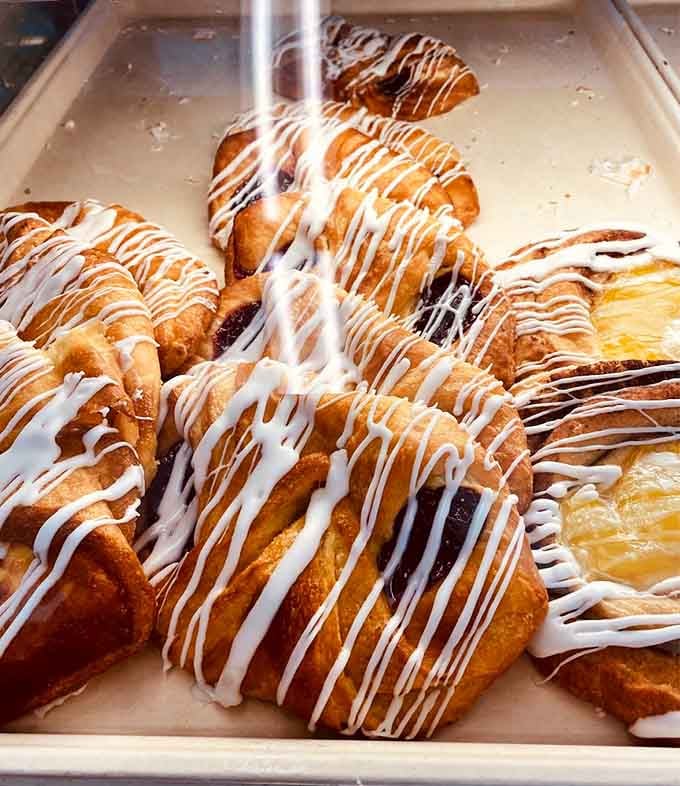 Danish pastries drizzled with icing, because sometimes breakfast needs to look as good as it tastes, right?