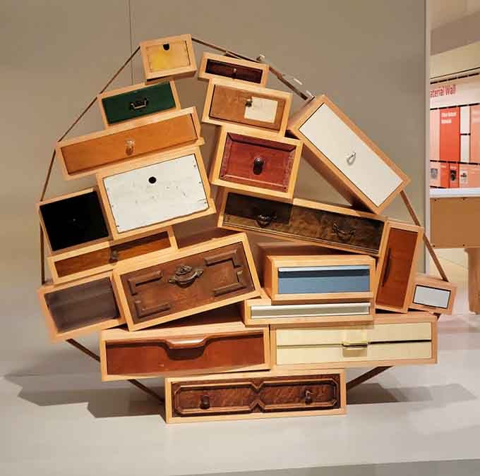 Drawers tumble and stack in impossible angles, turning functional furniture into a gravity-defying conversation starter.