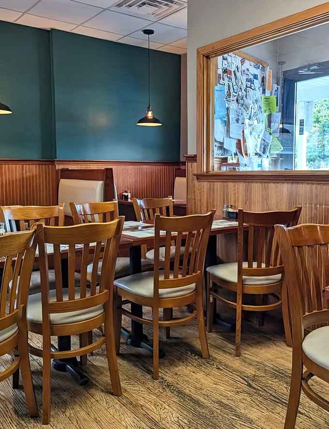 The teal walls and wooden accents create a dining space that feels both fresh and familiar, like visiting a friend's place.