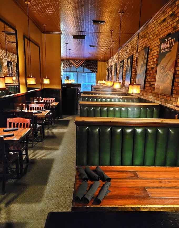 Green leather booths and exposed brick create that classic steakhouse vibe without trying too hard.