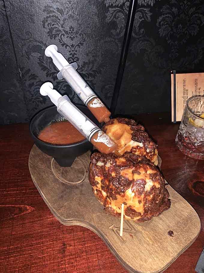 Soup shooters arrive with syringes stuck in them because subtlety isn't really on the menu here tonight.