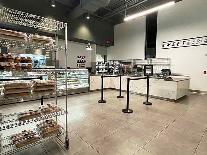 Behind that counter lies a refrigerated wall of possibilities, each shelf holding someone's future favorite dessert or breakfast.