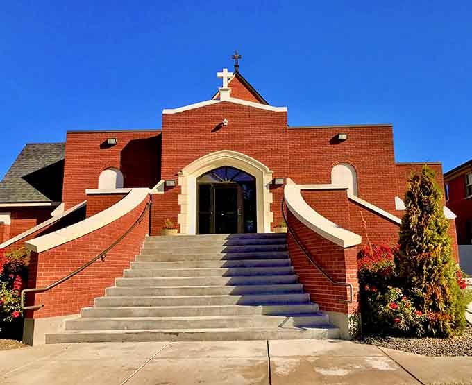 Sweeping stairs lead to graceful arches and brick warmth, where architecture speaks of faith and community gathering for generations.