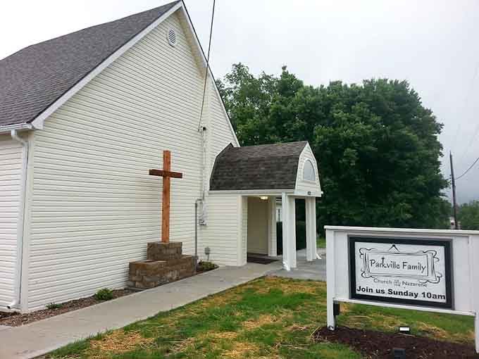Simple white clapboard and a welcoming cross remind us that faith communities thrive in the most unassuming spaces.