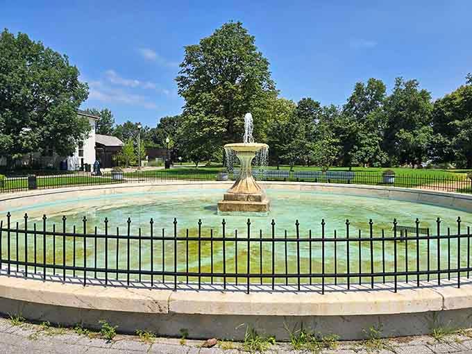 The classic fountain sits empty now, but its elegant design still adds old-world charm to this beloved green space.