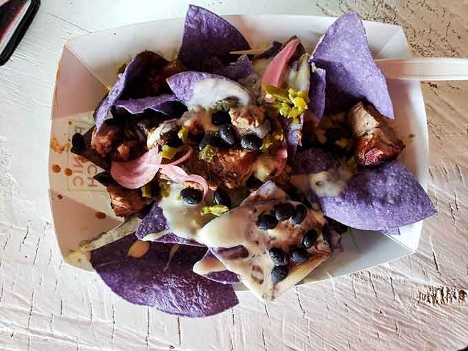 Brisket nachos loaded with toppings that would make your average chip platter weep with inadequacy and envy.