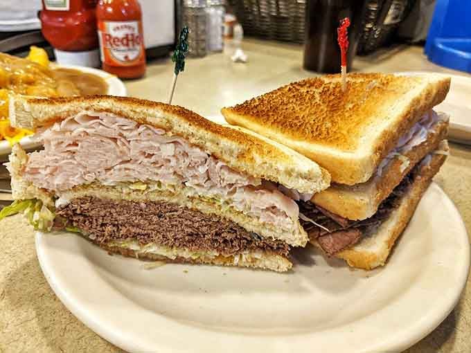 The double decker sandwich towers like a delicious skyscraper, making you wonder if you need a building permit to eat it.