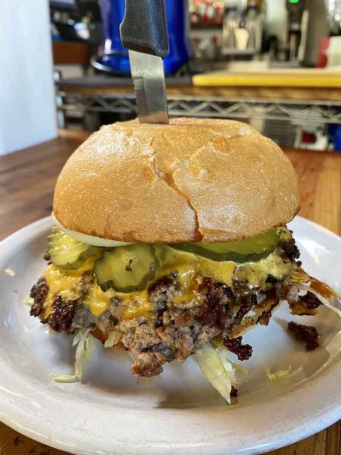 This burger stacked with brisket, cheese, and pickles proves that sometimes more really is more delicious.