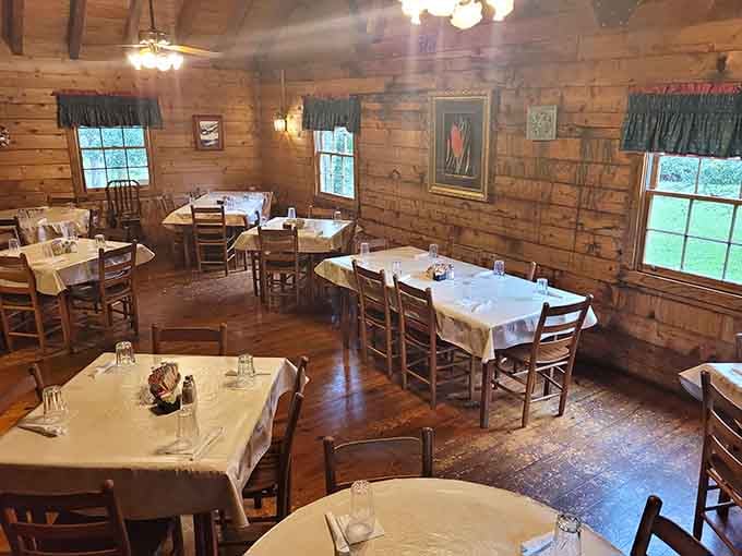 Crisp white tablecloths and wooden walls set the stage for a dining experience that feels both special and welcoming.
