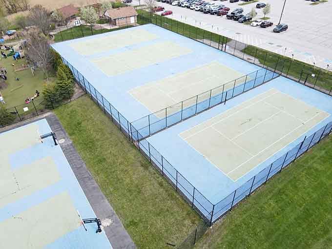 Tennis courts prove this park thinks beyond playgrounds, covering all the recreational bases beautifully.