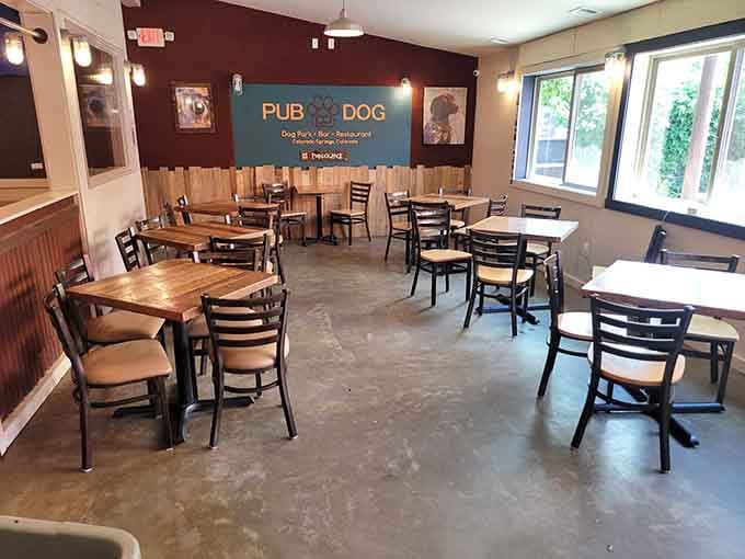 Clean, comfortable dining space where wooden tables and dog-themed decor create a welcoming, unpretentious atmosphere.