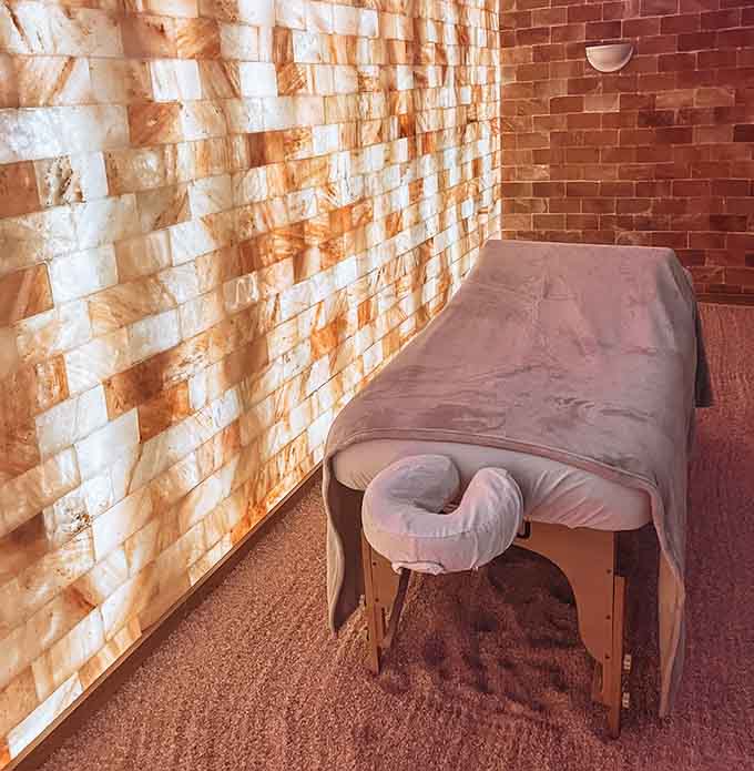 That illuminated salt wall creates an ambiance that makes regular massage rooms look like they're not even trying anymore.