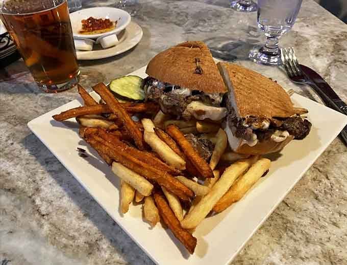The Philly Steak Panini comes loaded with meat and cheese, served alongside perfectly seasoned sweet potato and regular fries.
