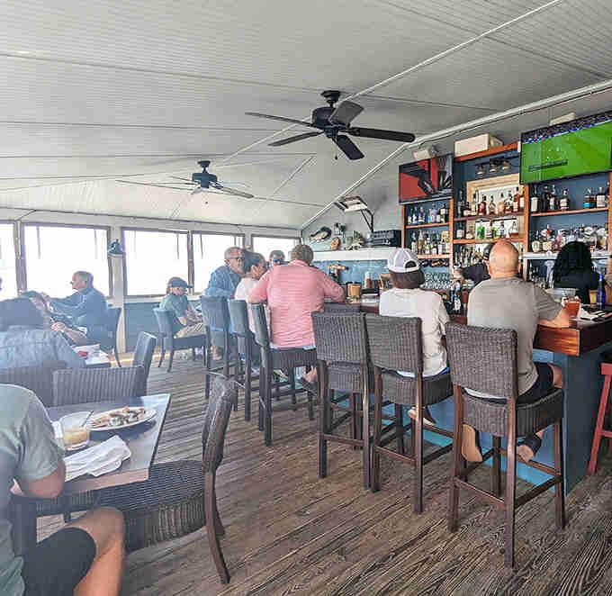 Ceiling fans, waterfront views, and a full bar stocked for serious business, this is coastal dining done absolutely right.