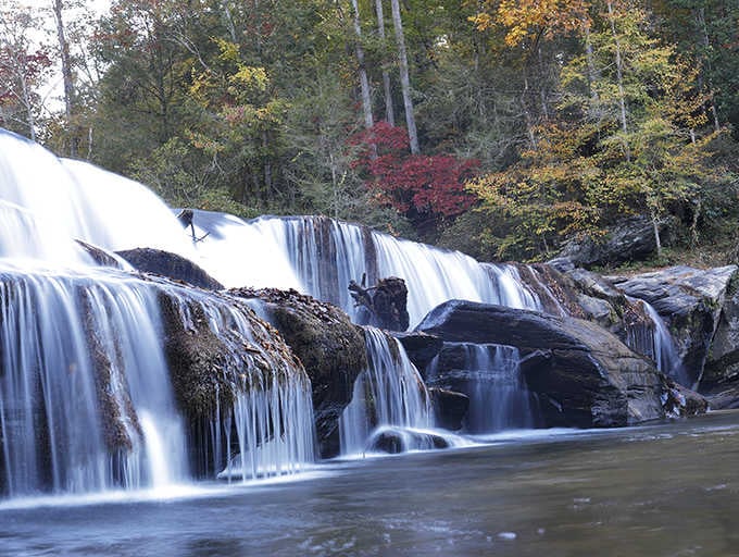 Multiple cascades tumble over layered rock formations, proving that Mother Nature really knows how to show off when she wants to.